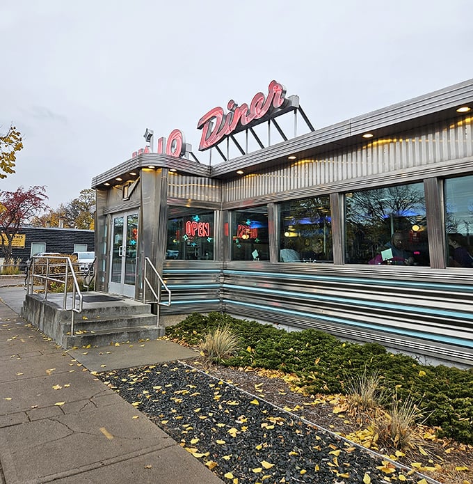 Hi-Lo Diner's sleek stainless steel exterior and neon signage create an unmistakable silhouette against the Minneapolis skyline.