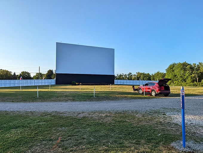 Sunset creates a stunning backdrop at Mayfield Road Drive-In as cars find their perfect viewing spots. That twilight glow makes the anticipation even sweeter.