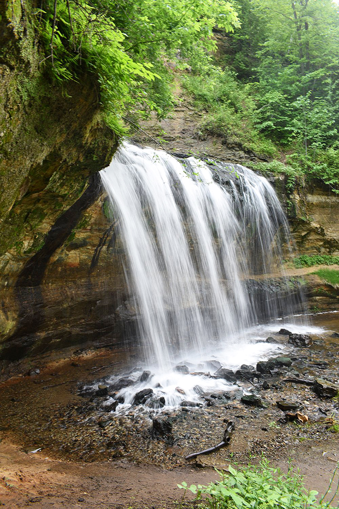 The layered limestone ledges of Cascade Falls create a stair-step effect, with each level offering a different melody in nature's symphony.