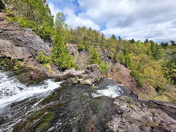 Surrounded by towering pines, this hidden waterfall feels like stumbling upon a secret garden in Michigan's wilderness.