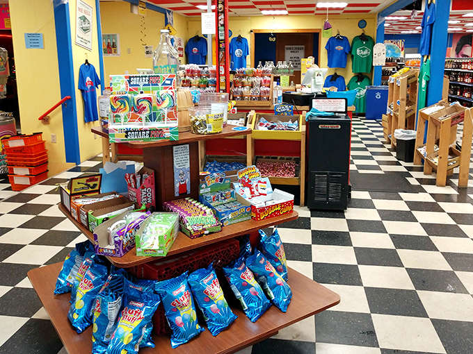 Candy displays at Grandpa Joe's create a rainbow of temptation, with treats stacked high on wooden shelves and colorful packaging that catches the eye.