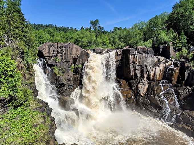 A peaceful stream above the falls gives no hint of the dramatic plunge waiting just downstream.