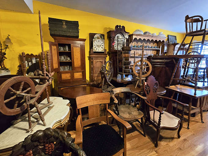 Warm yellow walls showcase wooden antiques at Paraphernalia, where grandfather clocks and spinning wheels tell stories of American craftsmanship.