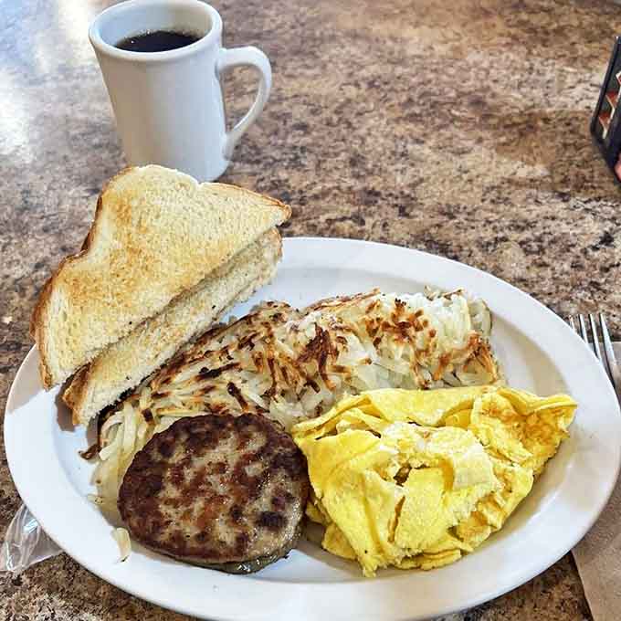 The holy trinity of breakfast perfection &ndash; golden hash browns with the ideal crisp-to-tender ratio, eggs that respect your "over medium" request, and toast ready for butter's warm embrace.