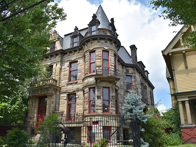 The cylindrical tower dominates the skyline, a stone exclamation point reminding the neighborhood that ordinary is overrated.