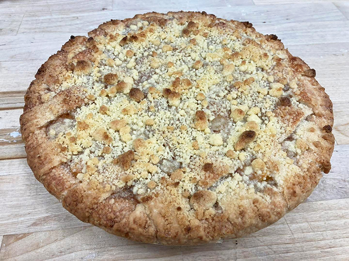 This apple crumble pie isn't just dessert; it's an edible heirloom, with a perfectly crimped edge and streusel topping that would make grandmothers everywhere nod in approval.