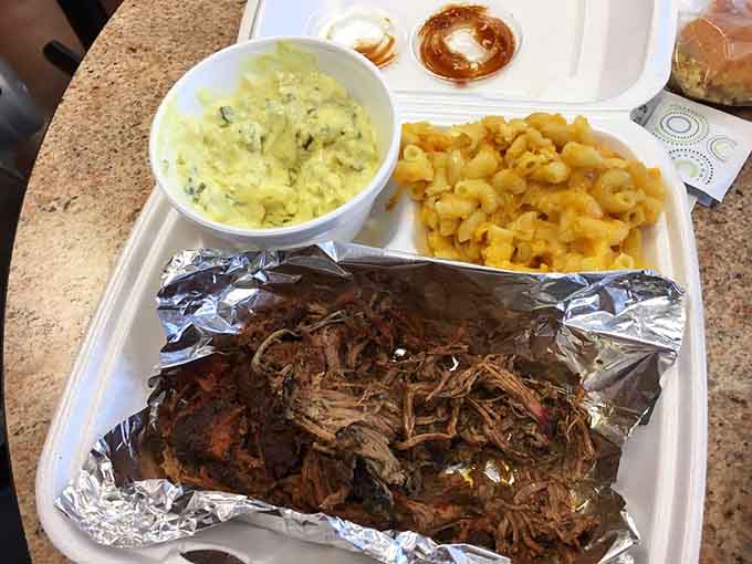 Behold the brisket dinner in all its foil-wrapped glory, complete with mac and cheese that'll make you forget every diet you ever considered starting.