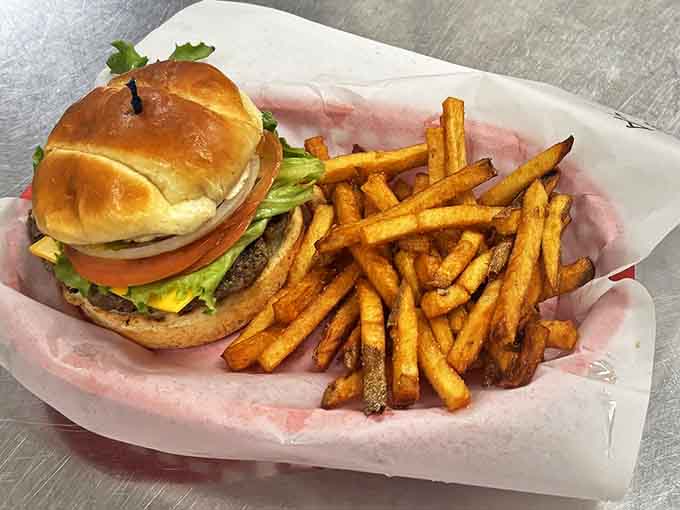 This isn't just any burger &ndash; it's a hand-formed masterpiece of juicy perfection on a golden bun, accompanied by crispy fries that could make a potato proud.