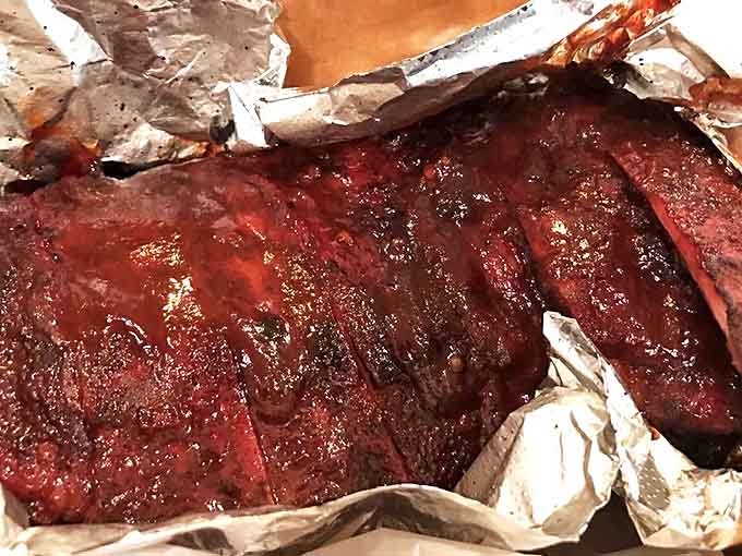 These baby backs glisten with a perfect bark, the meat pulling away from the bone with just enough resistance to remind you this is serious barbecue.