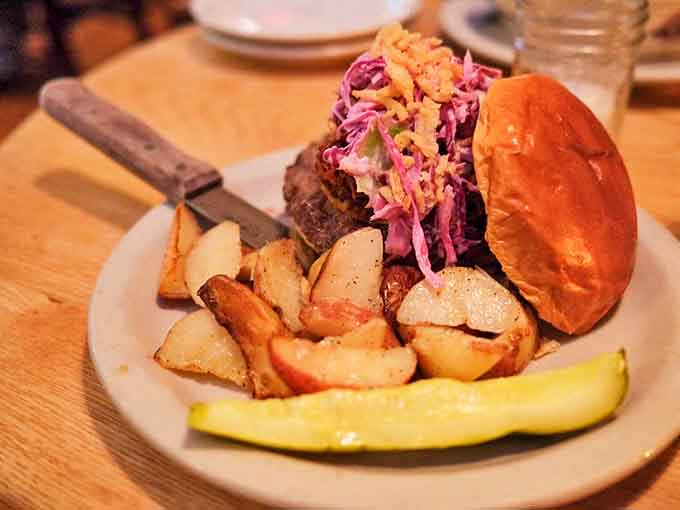 Not your average burger sermon! This creation comes with a side of perfectly crisped potatoes and a slaw that might just inspire religious conversion.