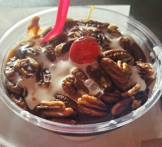 This Pecan Sundae isn't just dessert, it's architecture &ndash; layers of vanilla custard, hot fudge, and crunchy pecans crowned with a cherry sentinel.