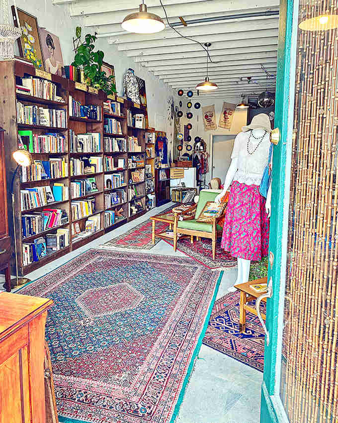 Literary worlds unfold beneath your feet on Persian rugs, where bamboo curtains filter sunlight onto shelves of waiting adventures.