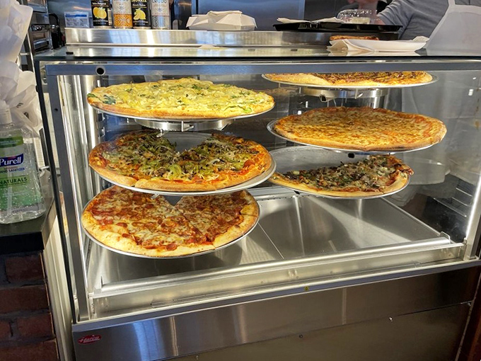 Borgata's artisanal pizzas wait in gleaming display cases, their perfectly baked crusts and colorful toppings showcasing the art of proper pie-making.