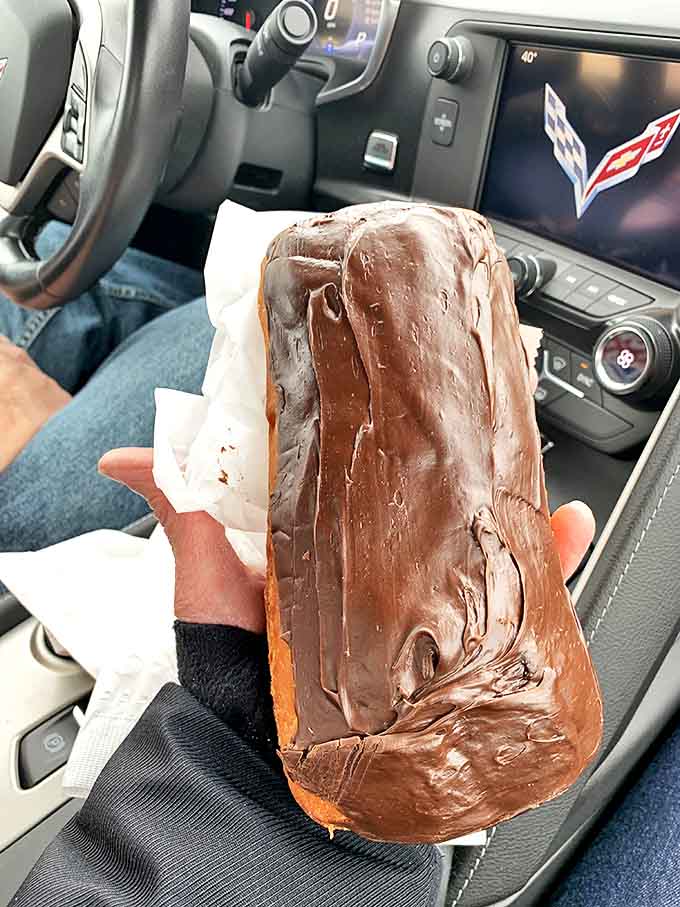 Behold the chocolate-glazed Long John in its natural habitat &ndash; your car, because you couldn't wait to drive home before taking that first bite.