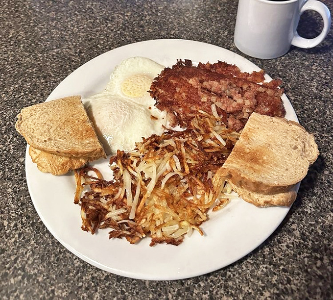 A classic breakfast plate that hits all the right notes &ndash; perfectly cooked eggs, crispy hash browns, and toast ready for that first satisfying bite.