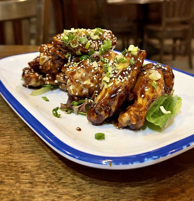 These aren't your average wings &ndash; Brit's Asian-inspired version comes glazed in a sweet-spicy sauce and sprinkled with sesame seeds and green onions.