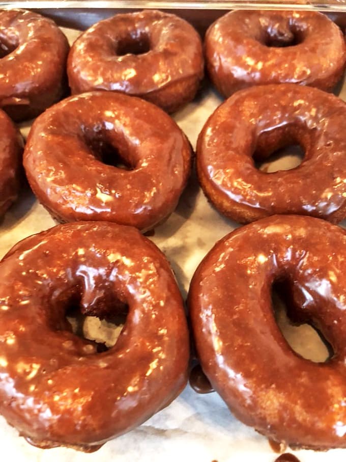 Glistening with sweet promise, these glazed beauties showcase the art of donut-making at its finest &ndash; crisp exterior giving way to pillowy softness within.