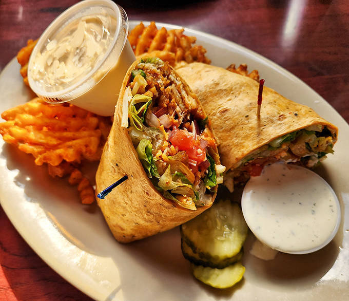 This Buffalo Chicken Wrap isn't just lunch &ndash; it's a portable flavor festival wrapped in a tortilla, with crispy waffle fries standing guard.