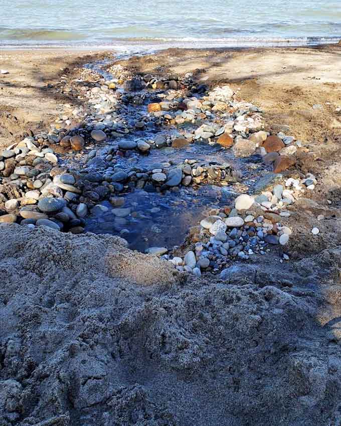 Nature's art installation &ndash; a bubbling stream creates its own path through smooth stones, each one polished by Lake Huron's patient waves.