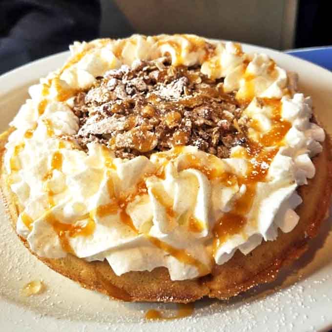 This Caramel Apple Crisp Waffle isn't just breakfast, it's an edible autumn fantasy with mountains of whipped cream and a caramel drizzle that dreams are made of.