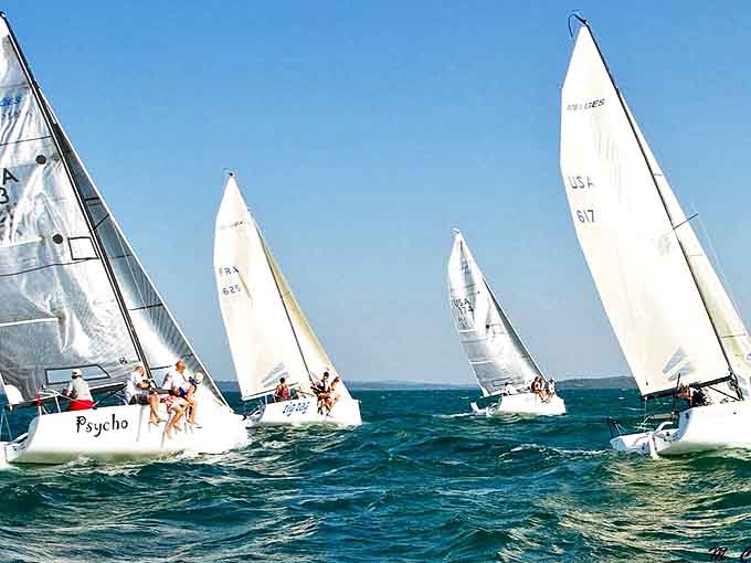 Sailboats dance across Charlevoix's azure waters like elegant swans, their white sails catching both wind and admiring glances.