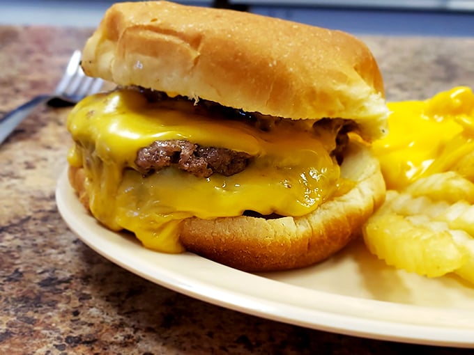 Behold the star attraction: a Wally's cheeseburger with cheese cascading down the sides like a yellow waterfall of deliciousness.