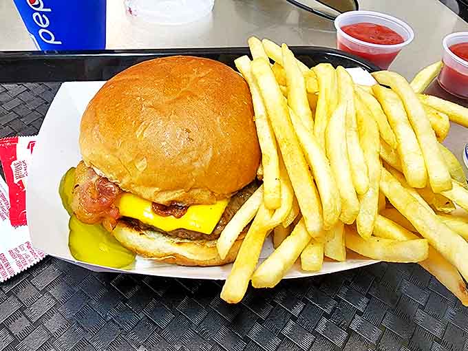 This isn't just a cheeseburger and fries – it's edible poetry on a paper tray, waiting to transport you back to simpler times.