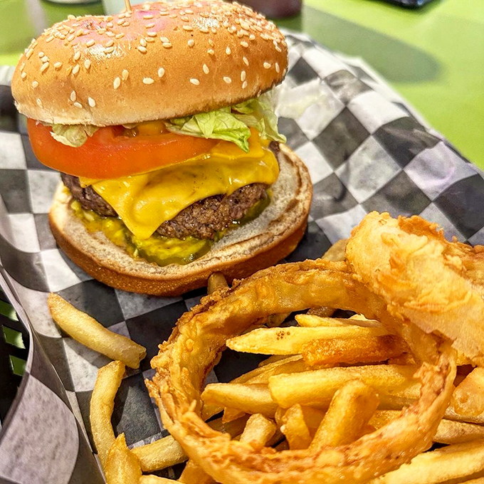 Behold the burger that launched a thousand return visits: pure beef, melted cheese, and enough golden fries to make you reconsider your afternoon plans.
