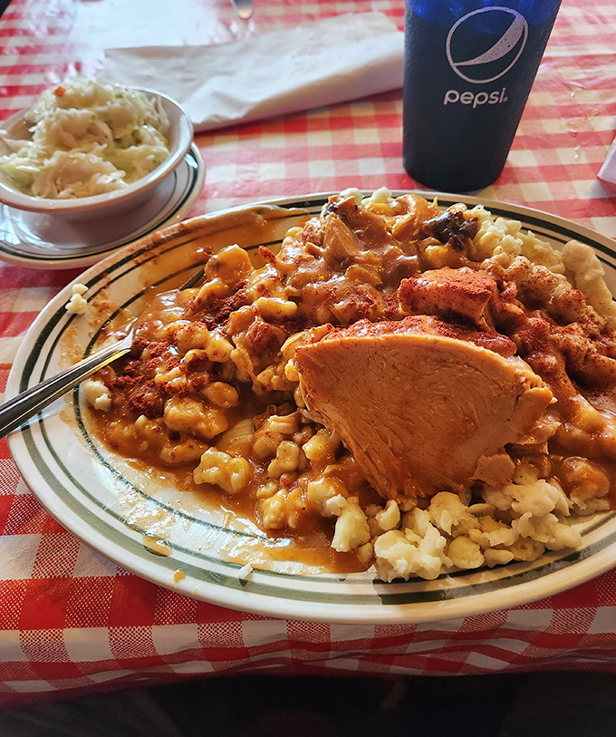 Hearty heaven: Chicken paprikash over dumplings with a side of coleslaw – a plate that's worth the drive to Toledo.
