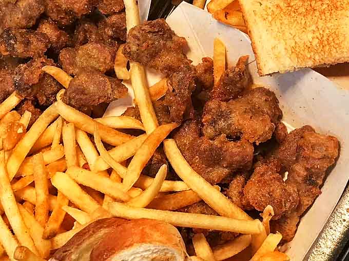 Golden, crispy chicken gizzards nestled among perfect fries – a combination that transforms skeptics into evangelists with just one crunchy, flavorful bite.