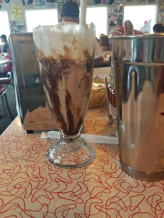 This chocolate shake isn't just a drink, it's a towering monument to dairy perfection that demands both a spoon and straw.
