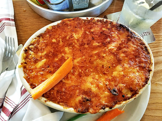 Golden-crusted and bubbling hot, the lobster mac and cheese arrives like a revelation, promising creamy perfection beneath its caramelized top.