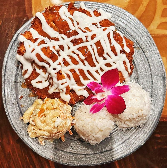 Coconut chicken arrives like edible sunshine &ndash; crispy, golden exterior giving way to tender meat, with that vibrant orchid adding Instagram-worthy appeal.