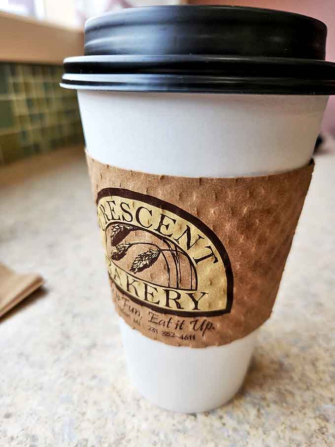 That coffee cup with the Crescent Bakery logo is holding liquid motivation, the kind that makes Monday mornings slightly less Monday-ish.