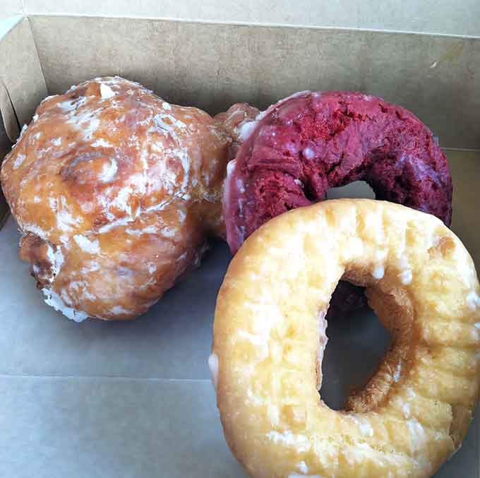 Behold the holy trinity: a massive apple fritter, red velvet indulgence, and a buttermilk old fashioned that could make grown adults weep with joy.