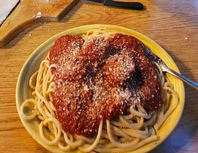 That spaghetti isn't just pasta with sauce, it's a religious experience served on a plate with enough cheese to make any cardiologist nervous.