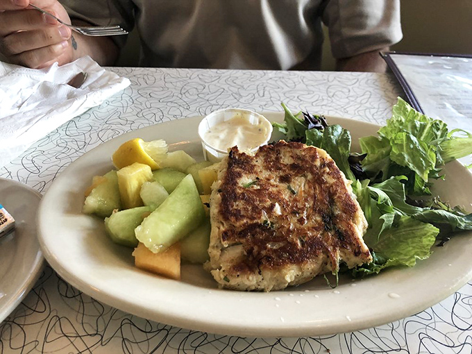 This isn't just any crab cake &ndash; it's a golden-crusted masterpiece with barely-there filler, letting the sweet crab meat shine through with every fork-tender bite.