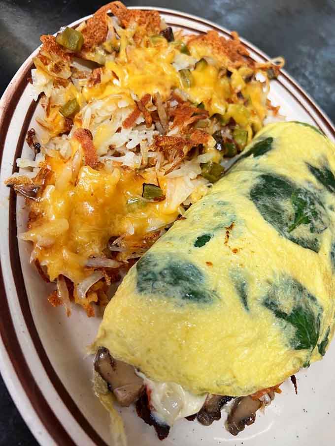 That omelet paired with perfectly crispy hash browns is what breakfast dreams are made of, folks.