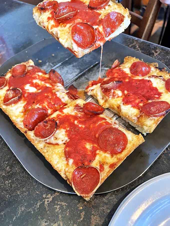 Detroit-style pizza perfection: crispy-cornered pepperoni squares with that signature caramelized cheese edge that pizza dreams are made of.