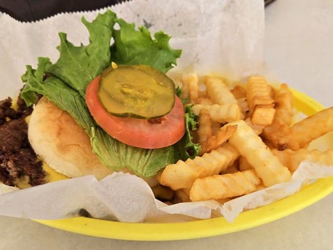 Double Cheeseburger: A masterpiece of simplicity &ndash; fresh lettuce, juicy tomato, and pickle slices framing a patty that's been kissed by the grill just right.