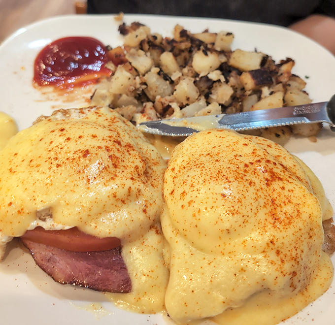 Behold the star attraction &ndash; Eggs Benedict with perfectly poached eggs, silky hollandaise, and those home fries that deserve their own fan club.