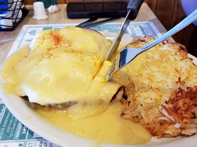 Eggs Benedict swimming in hollandaise with perfectly crispy hash browns – breakfast doesn't get more beautiful than this.