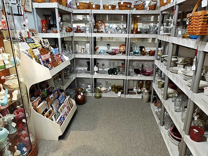 Crystal, Depression glass, and vintage dishware sparkle under the lights, each shelf a rainbow of American domestic history.