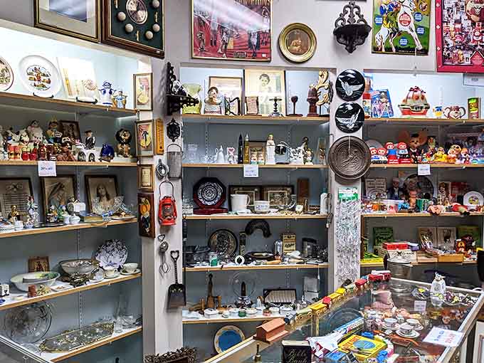 Porcelain personalities stand at attention, silently watching shoppers from their glass kingdom of collectible curiosities.