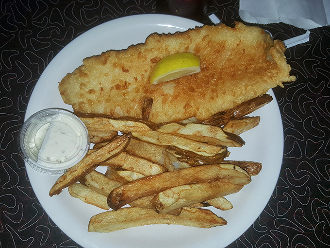 Golden, crispy batter shatters to reveal flaky white fish within &ndash; this isn't just fish and chips, it's edible poetry served with hand-cut potatoes.