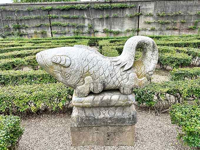 Fish stone sculpture: This stone fish looks like it's been caught mid-gossip. "Did you hear what the koi pond said about the fountain?"