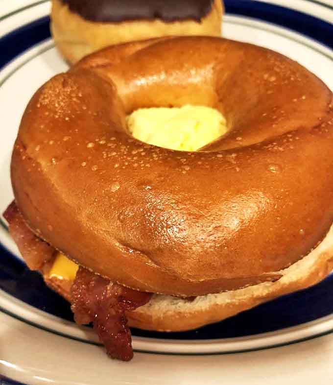 This isn't just any breakfast sandwich &ndash; it's a masterpiece of perfectly cooked bacon, fluffy eggs, and melted cheese on a toasted bagel.