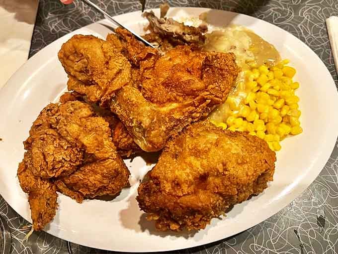 Aunt Liz's Golden Fried Chicken arrives with a crackling, perfectly seasoned crust that would make Colonel Sanders weep with jealousy.