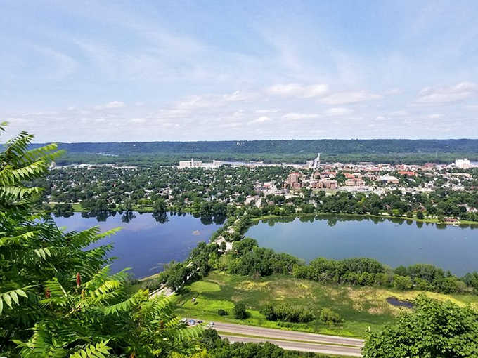 Winona unfolds like a miniature model village below, with the Mississippi curving through like nature's perfect design element.