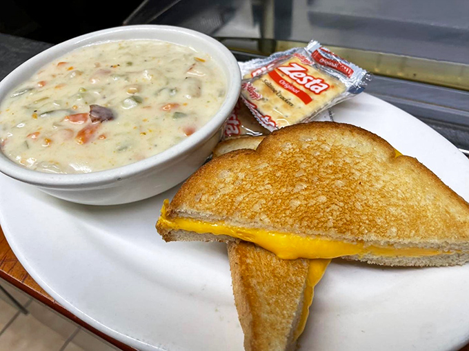 A perfect pairing: creamy soup alongside a golden grilled cheese sandwich that would make any Wisconsin dairy farmer proud.